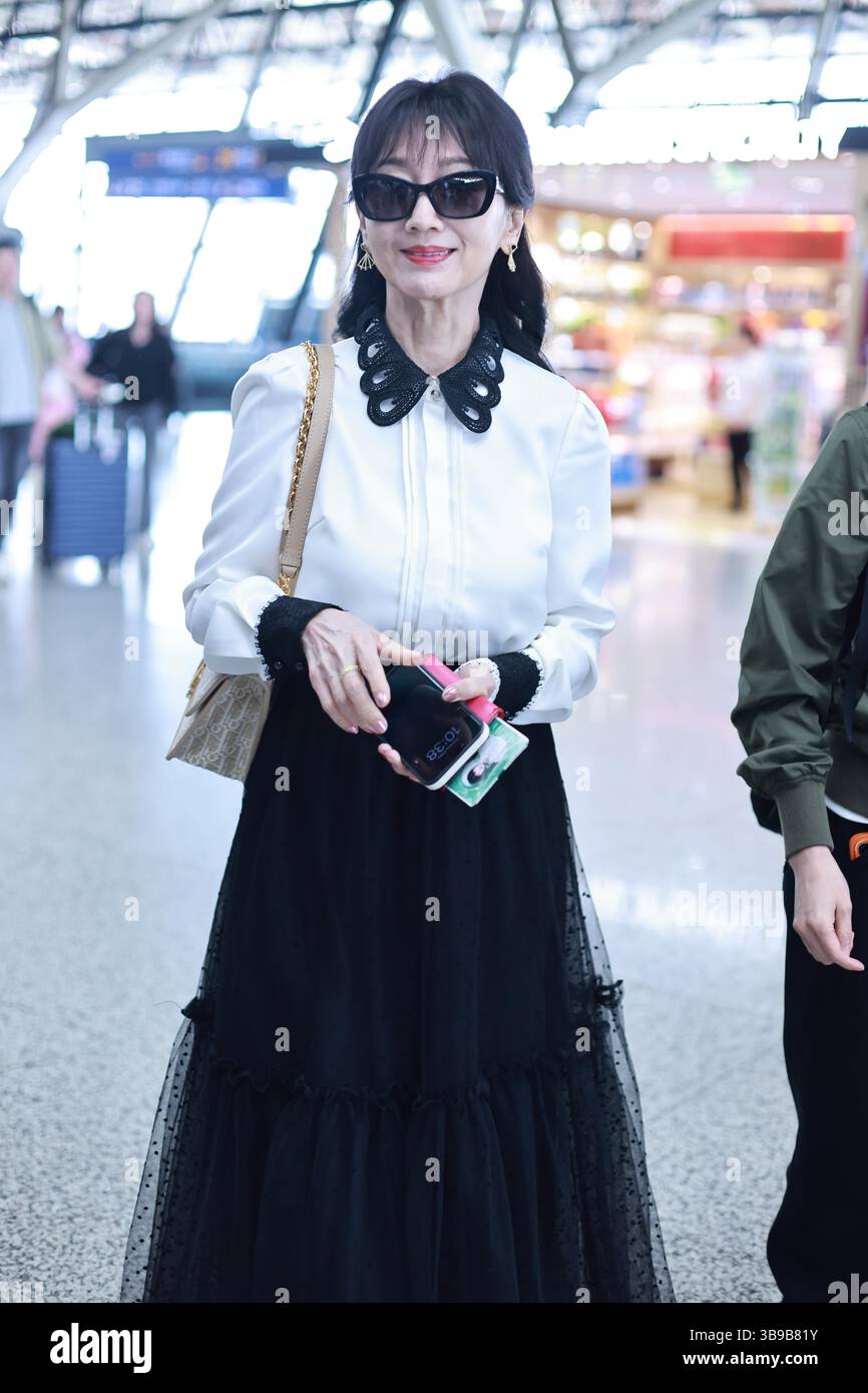 Hong Kong actress Angie Chiu appears at the airport in Shanghai, China ...