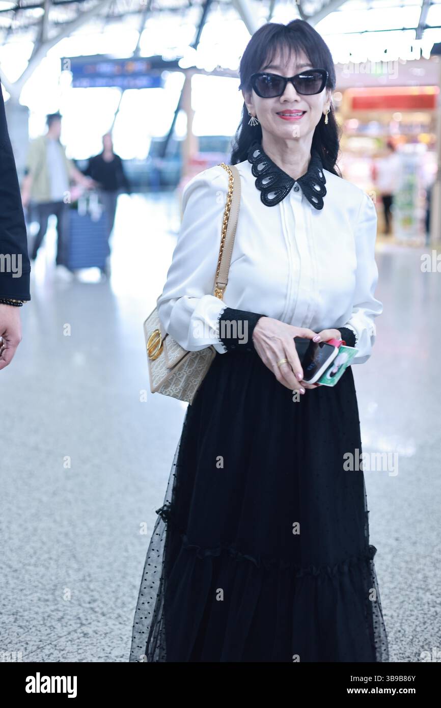Hong Kong actress Angie Chiu appears at the airport in Shanghai, China ...