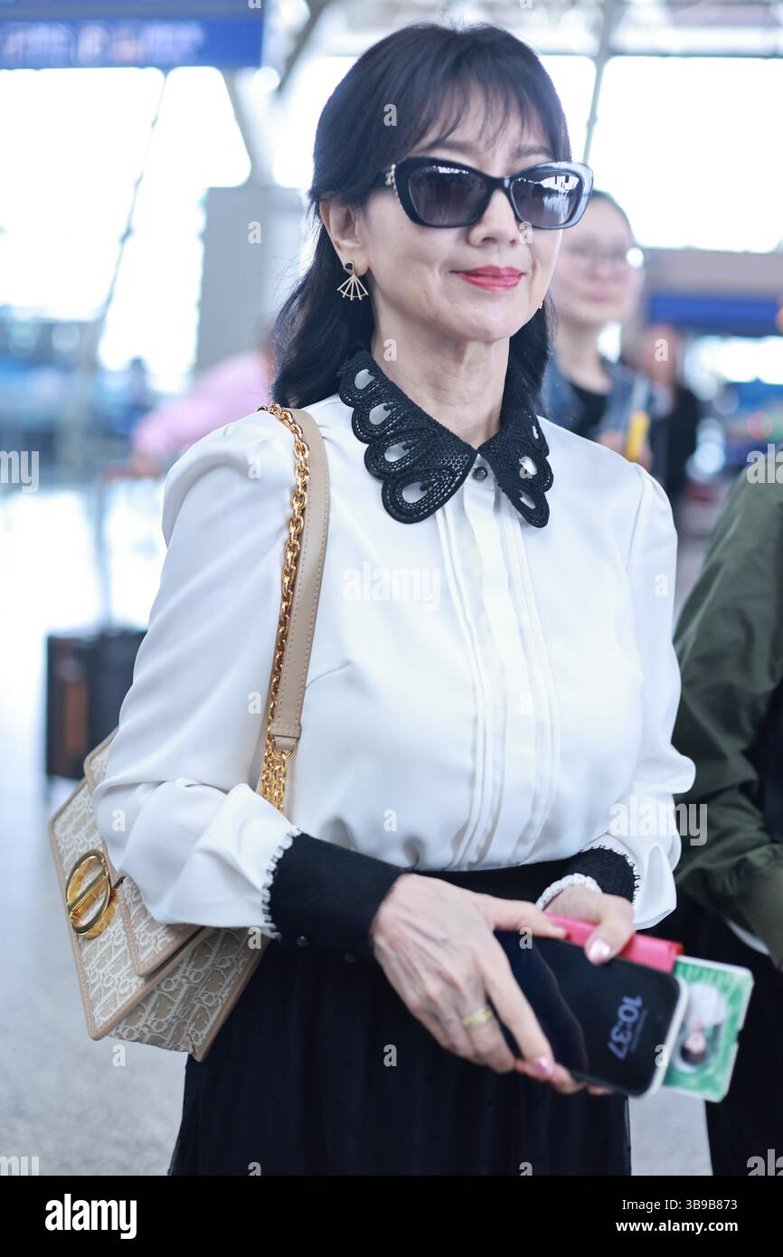 Hong Kong actress Angie Chiu appears at the airport in Shanghai, China ...