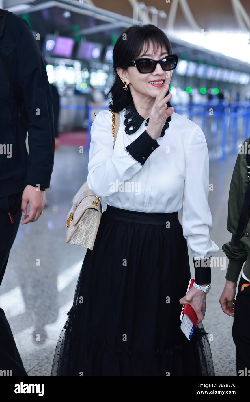 Hong Kong actress Angie Chiu appears at the airport in Shanghai, China ...