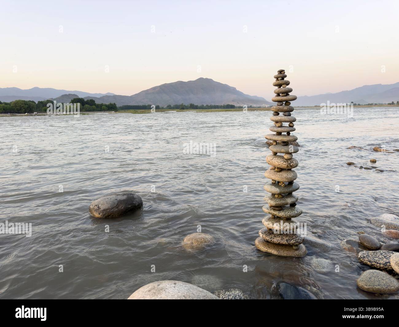 River stone stacked on the bank of river. Balance river stone tower ...