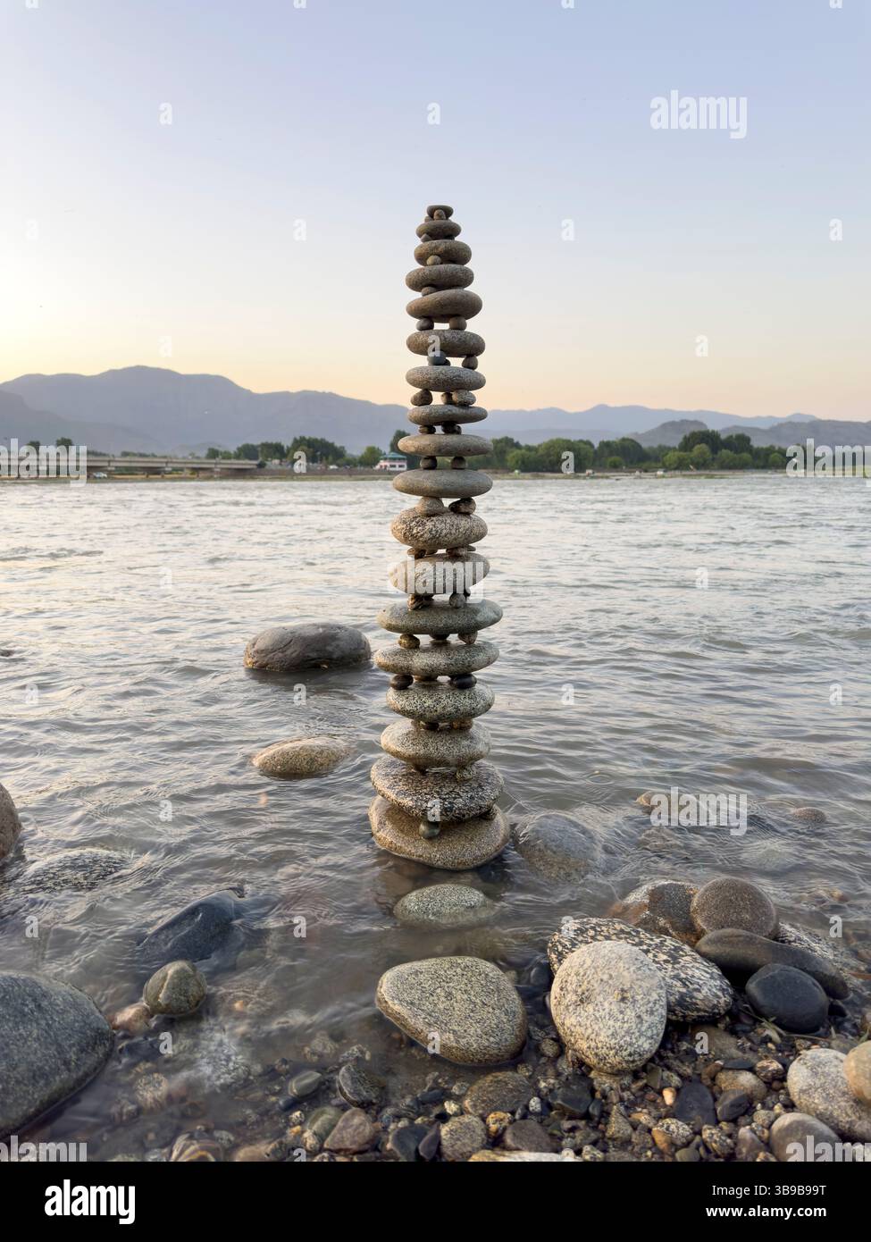 Pyramids of stone stack in shallow river flowing water Stock Photo - Alamy