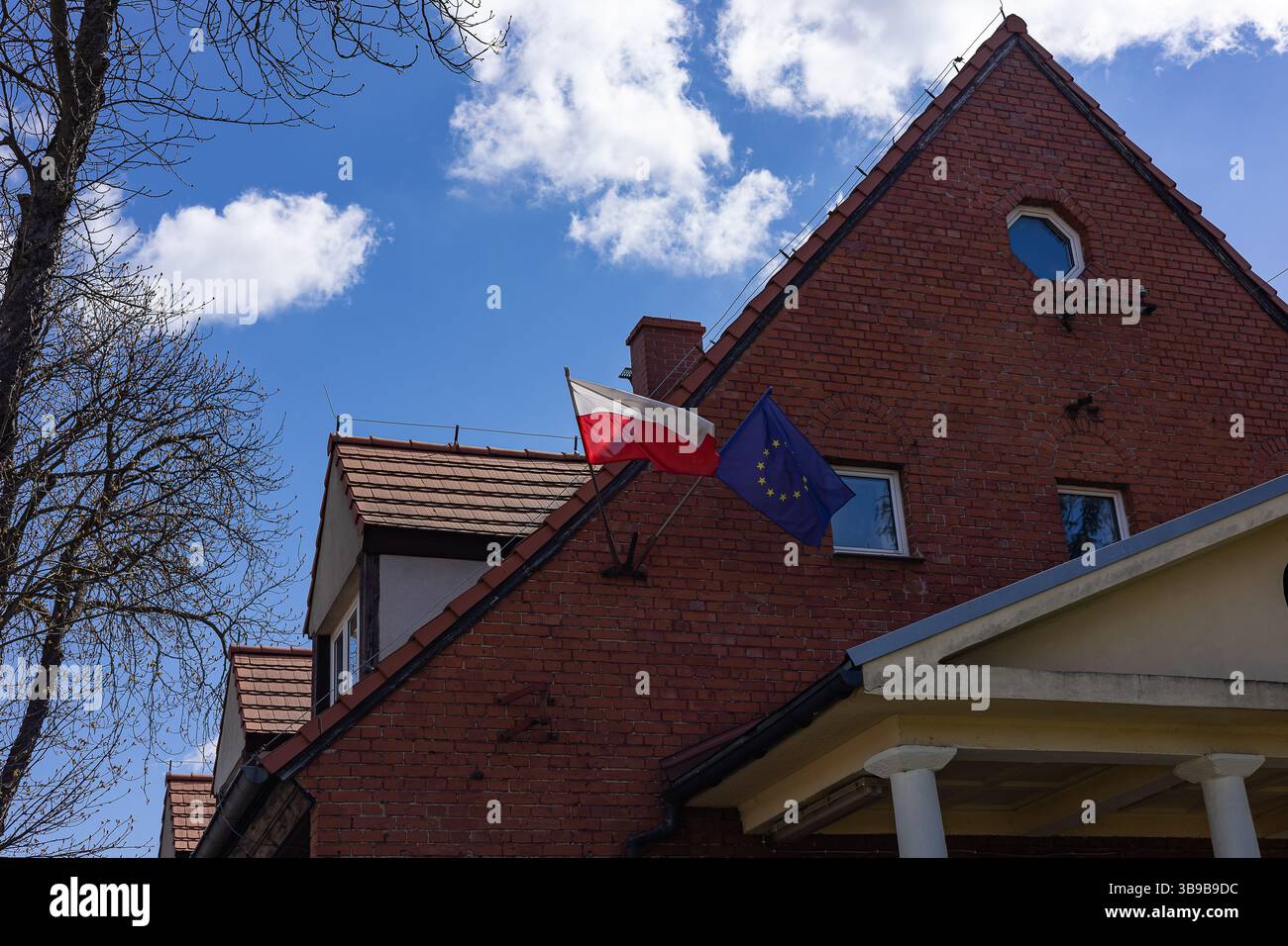 Polish and European Union flags waving side by side on traditional red ...