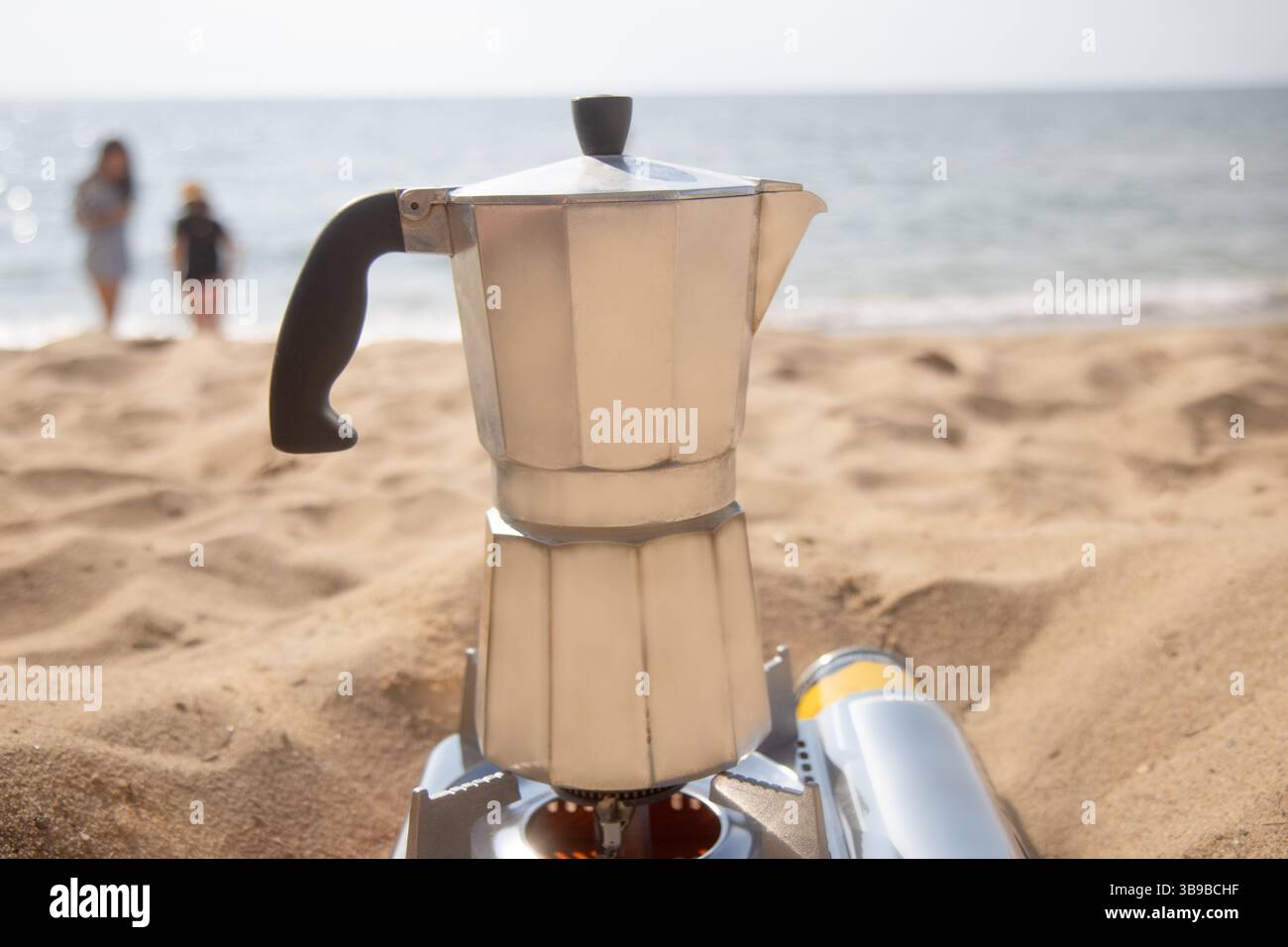 geyser coffee maker brews coffee on portable gas stove on seashore ...