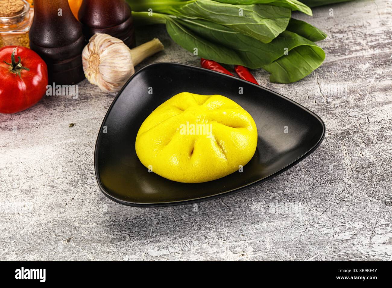 Asian stuffed steamed yellow Bun Bao Stock Photo - Alamy