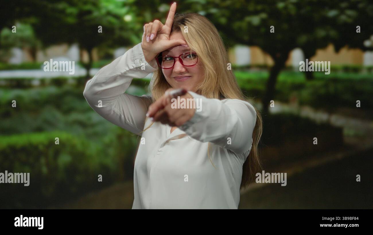 Woman making loser gesture outdoors hi-res stock photography and images ...