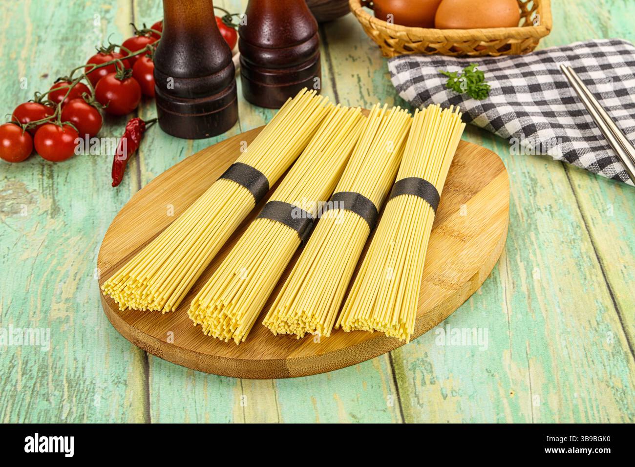 Raw dry uncooked yellow egg noodles Stock Photo - Alamy
