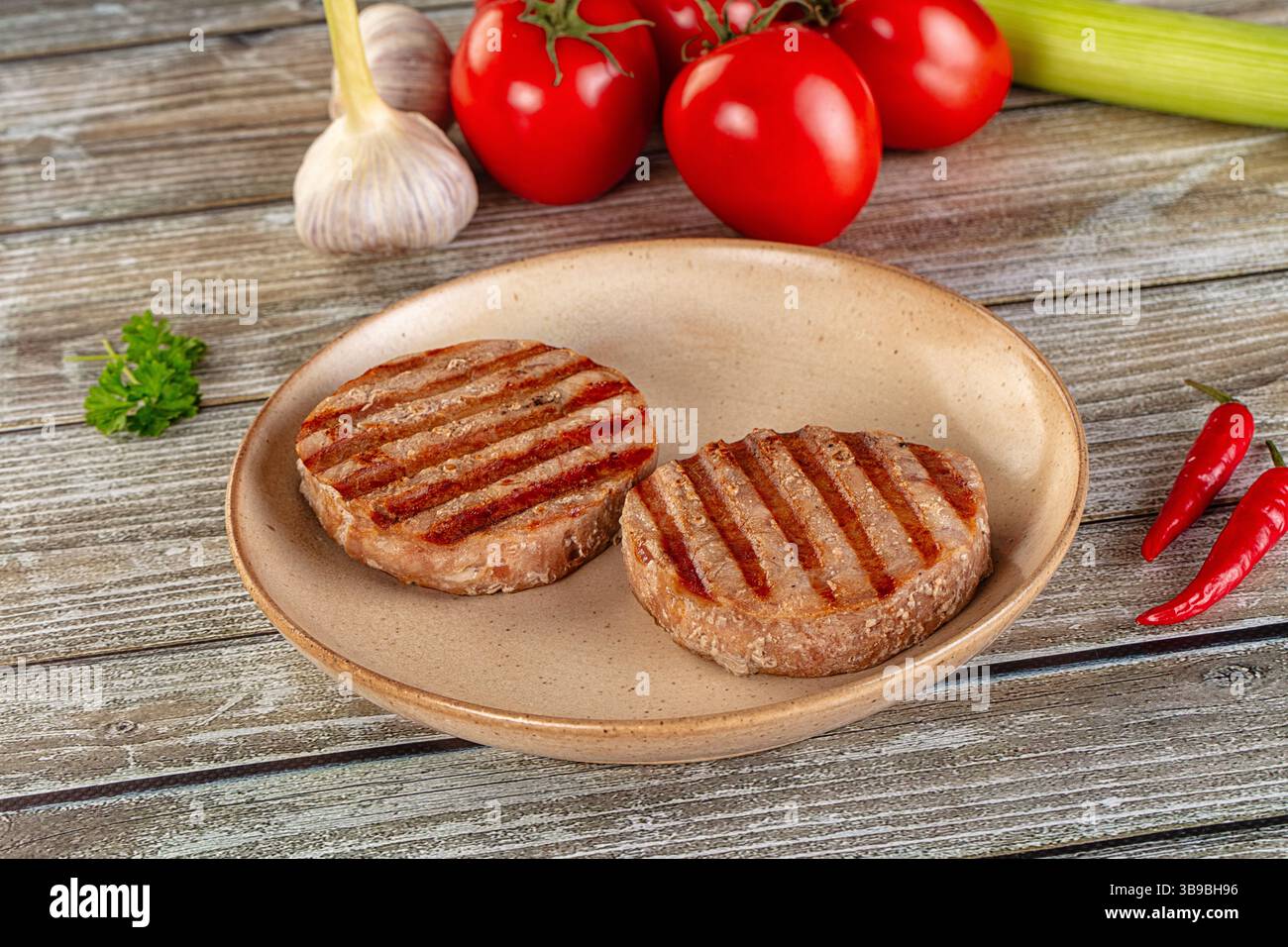 Grilled tuna steak fillet round medallion Stock Photo - Alamy