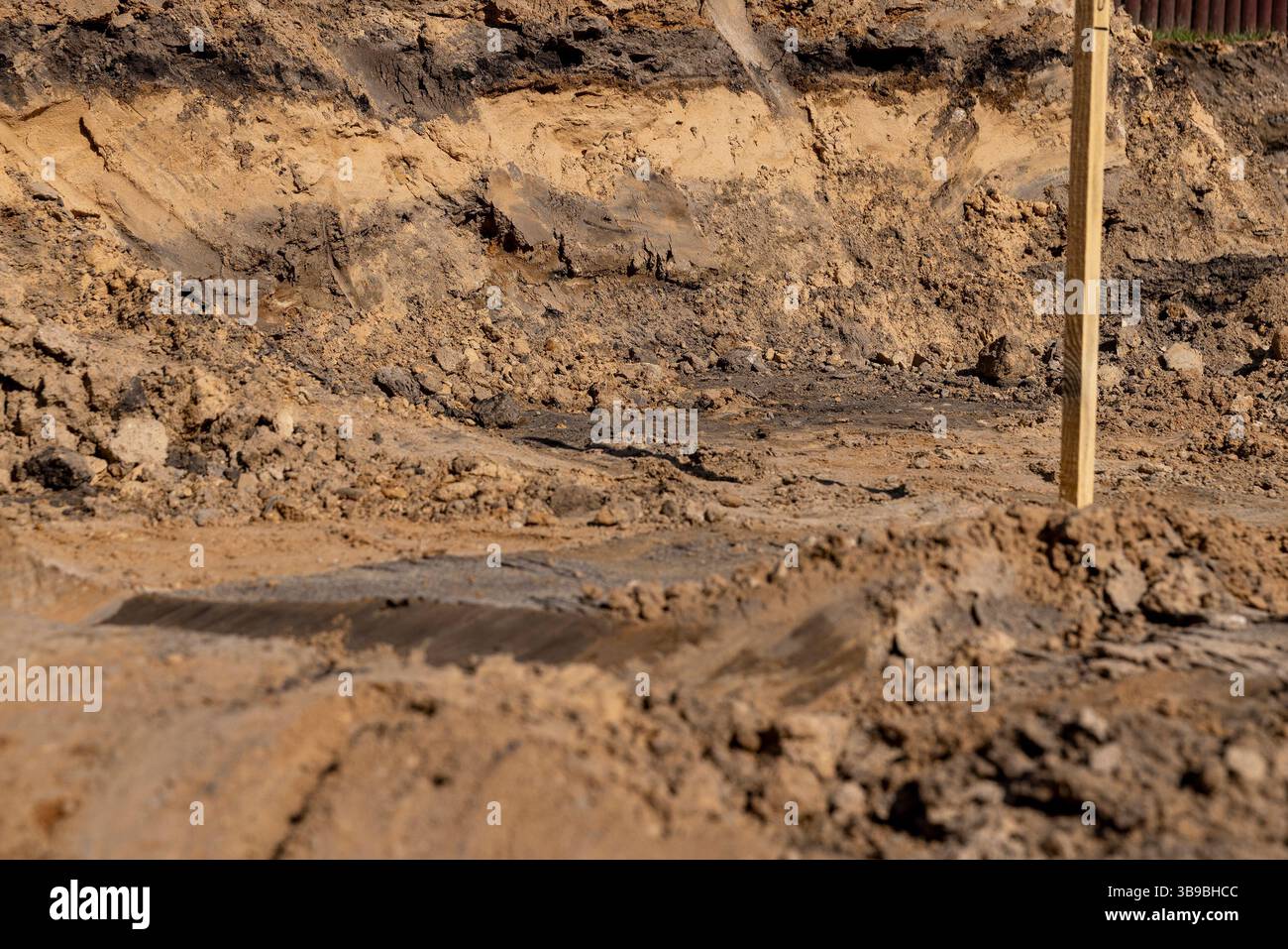 construction work during the excavation of a pit for laying different ...