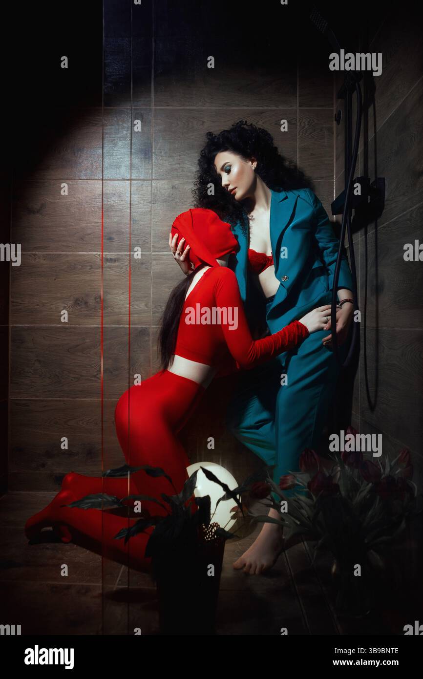 A woman towers above a red-masked figure, commanding the frame with ...