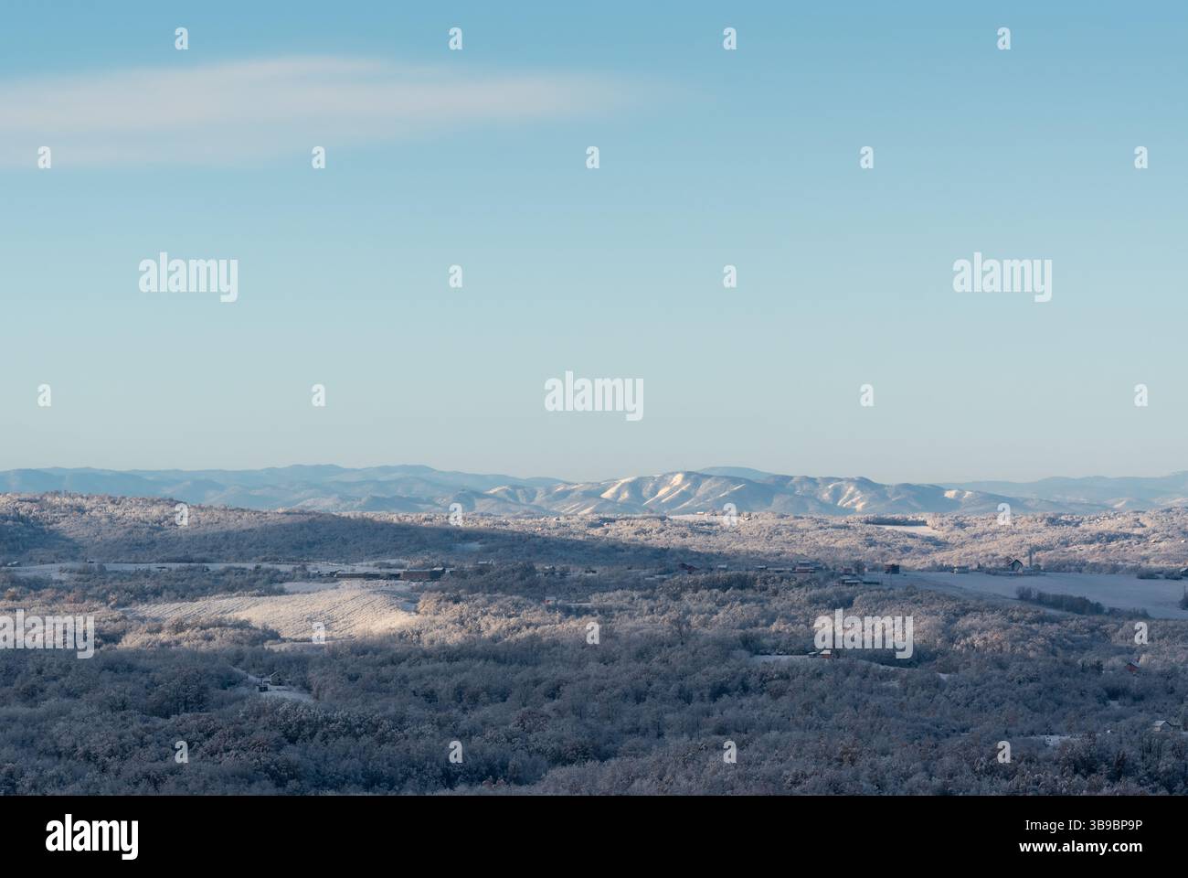 Hilly village covered with frost after cold winter night, rural ...