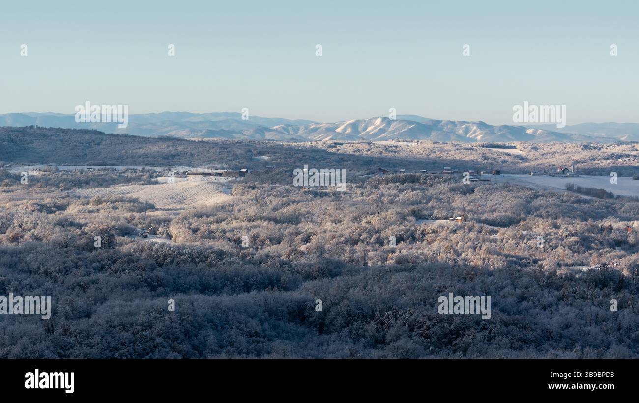 Hilly village covered with frost after cold winter night, rural ...