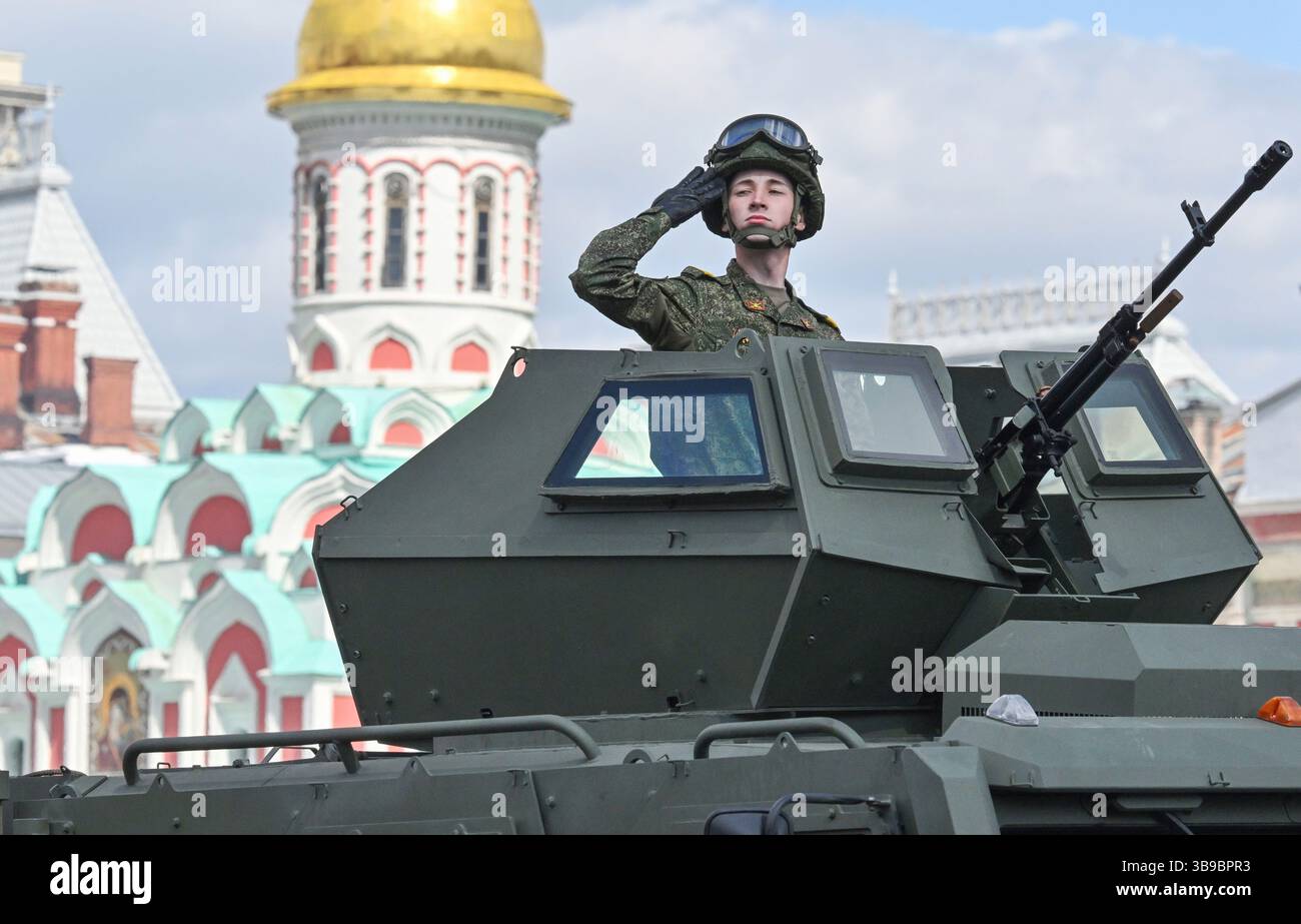 A Russian soldier rides on an armored vehicle VPK-Ural in Red square ...