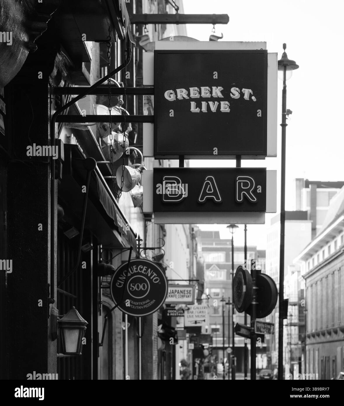 London, England - 28th April 2025: A hanging sign for a bar and other ...