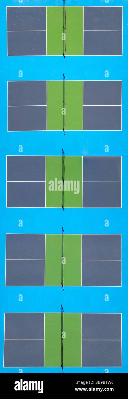 Top-down aerial view of five vibrant pickleball courts with green ...