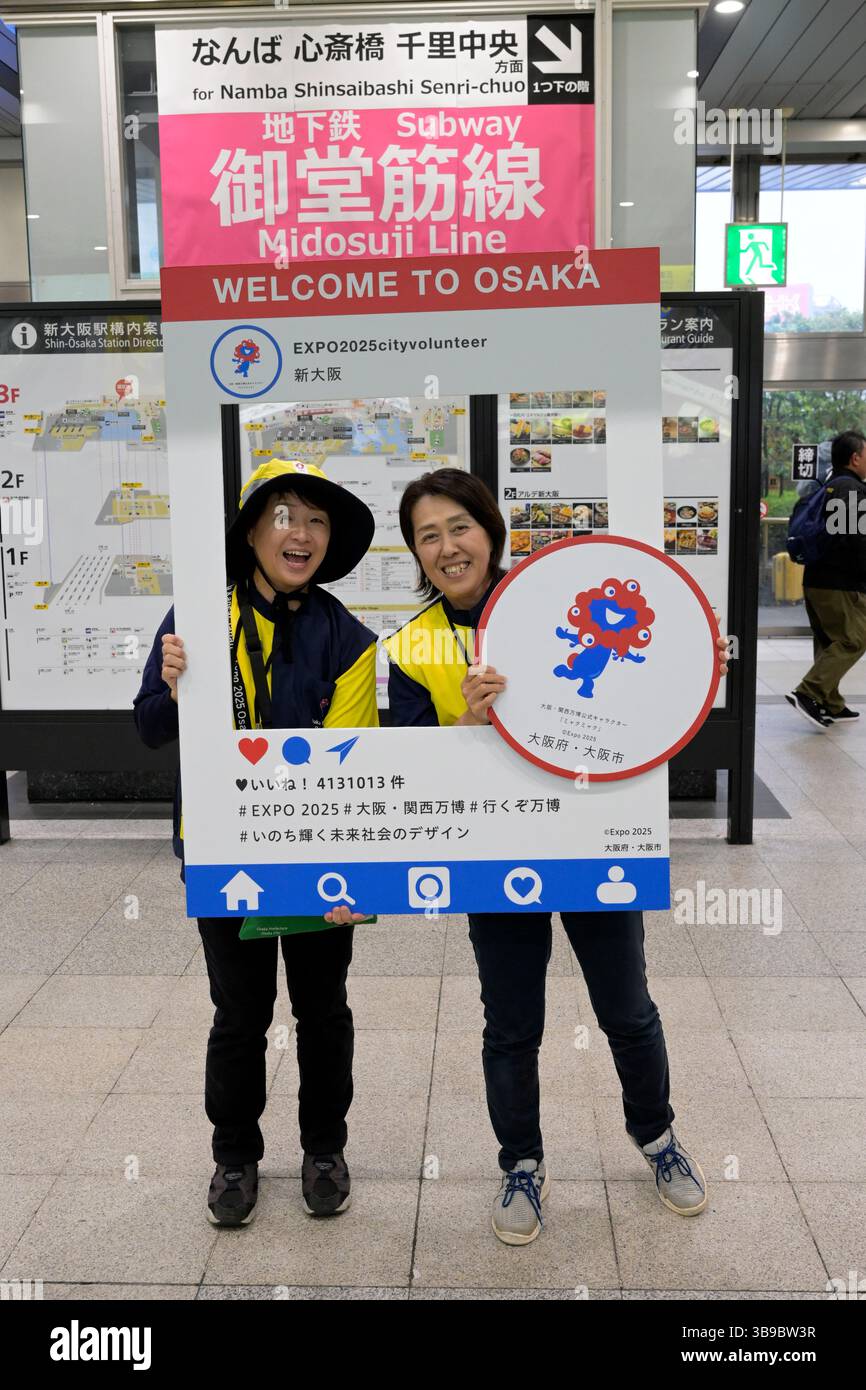 Japanese women holding welcome in Osaka sign in Osaka railway station ...