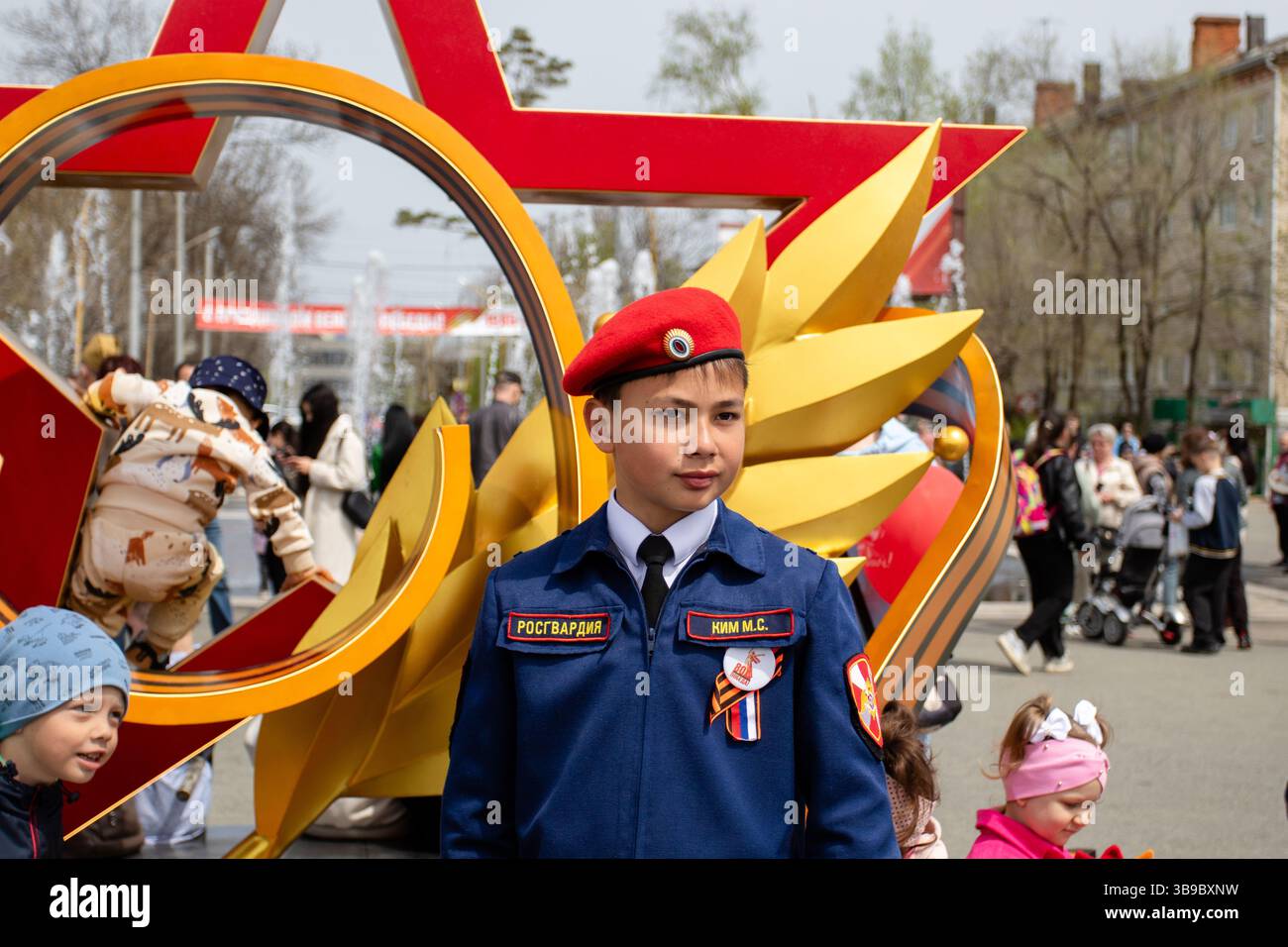 Artyom, Russia. 09th May, 2025. A boy at the background of Victory Day ...