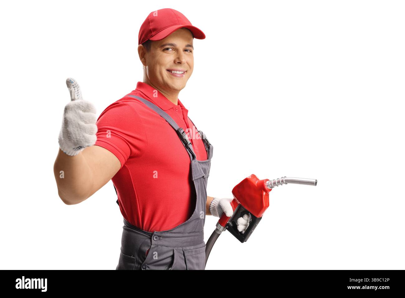 Petrol station worker holding a petrol refueling gun and gesturing ...