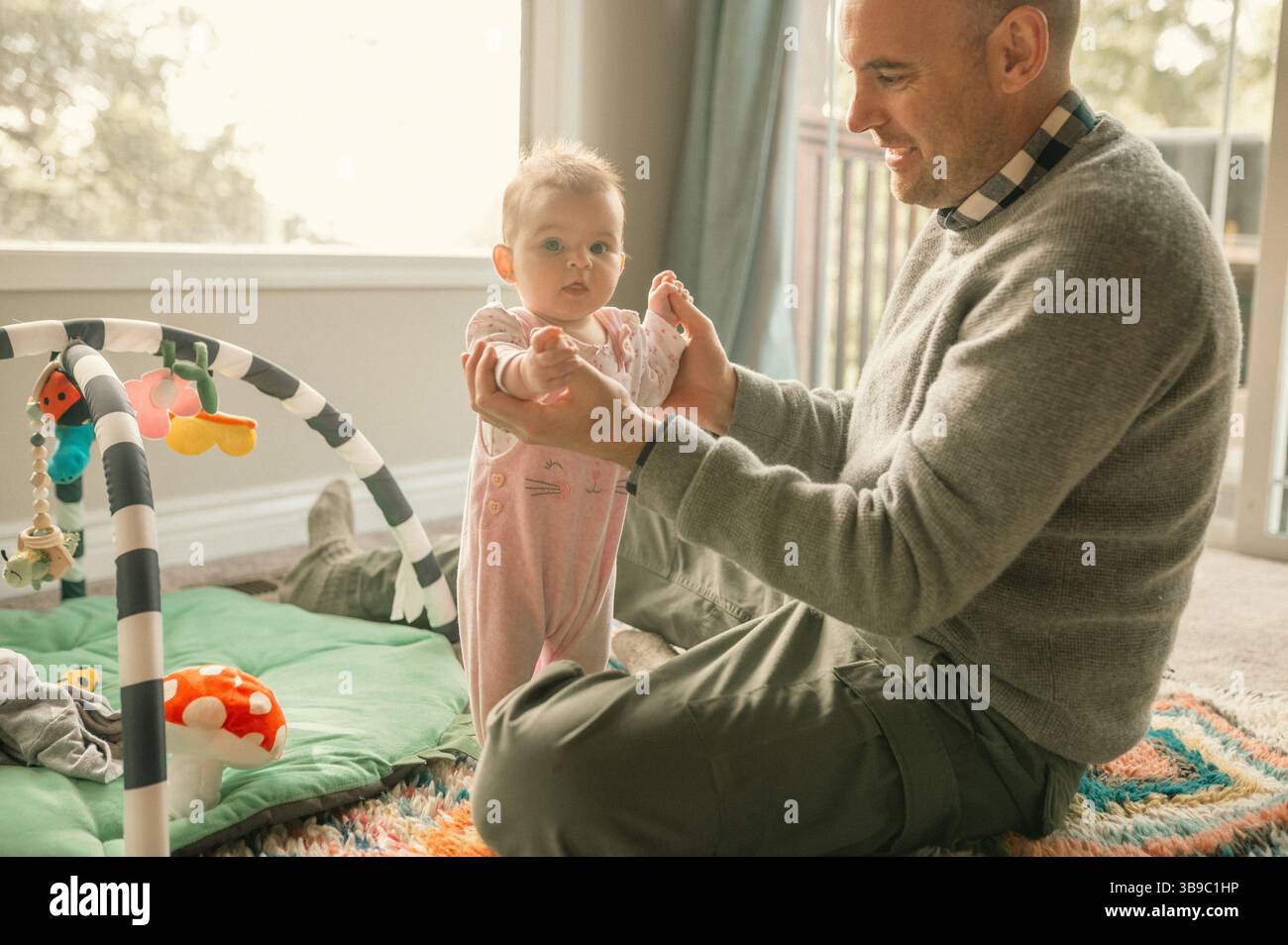 Father supporting baby learning hi-res stock photography and images - Alamy