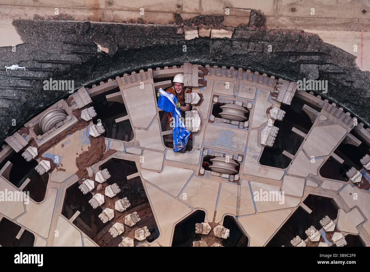 Pilots wave flags after boring machine Mary Ann broke through at Washwood Heath depot, 2 miles ...