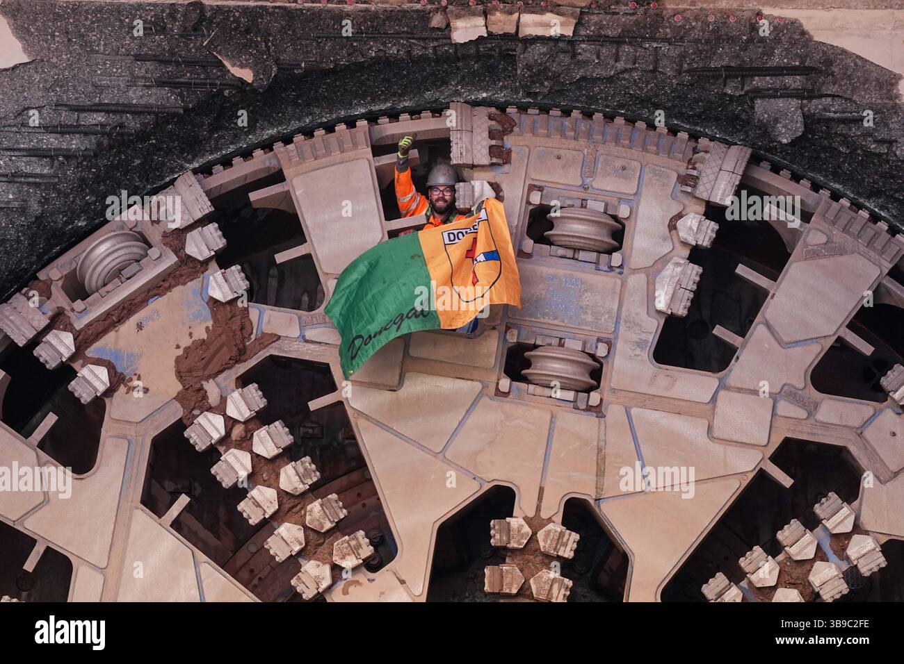 Pilots wave flags after boring machine Mary Ann broke through at Washwood Heath depot, 2 miles ...