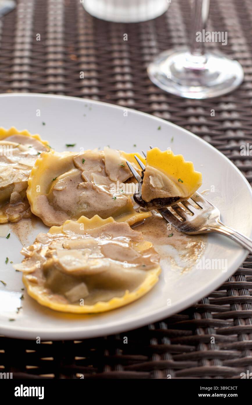 Mushroom ravioli cut open with a fork vertical Stock Photo - Alamy