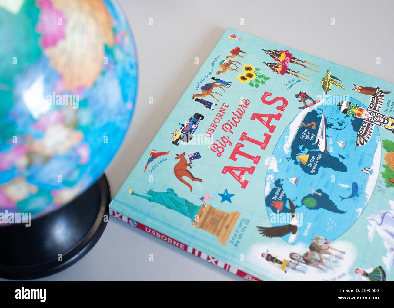 Close up image of a children's big picture atlas book by Usborne and a ...
