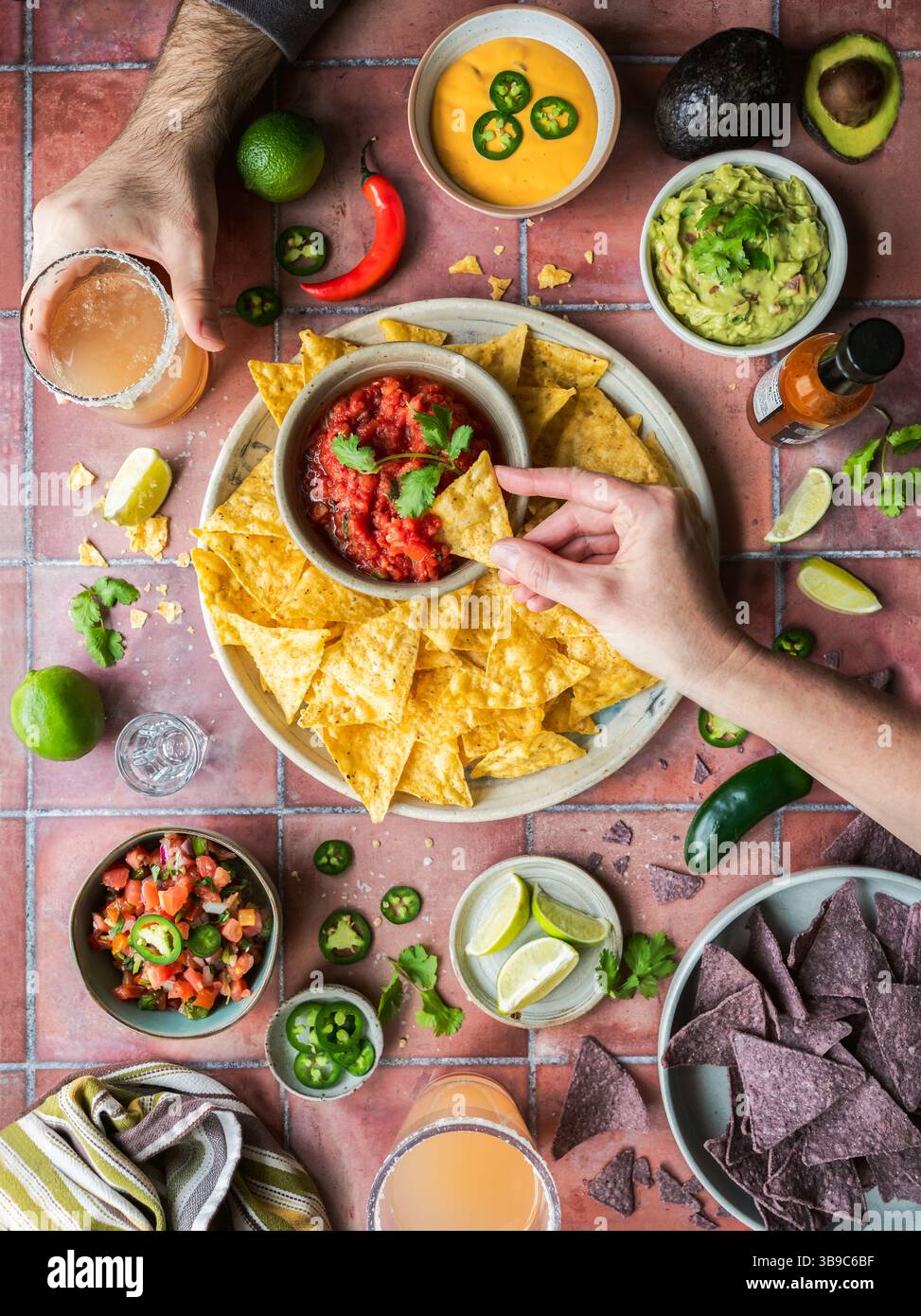 Hands dip tortilla chips fresh hi-res stock photography and images - Alamy
