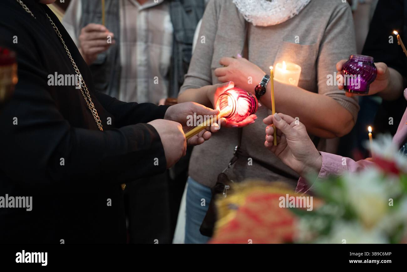 Lighting the Easter Holy Fire from candles Stock Photo - Alamy