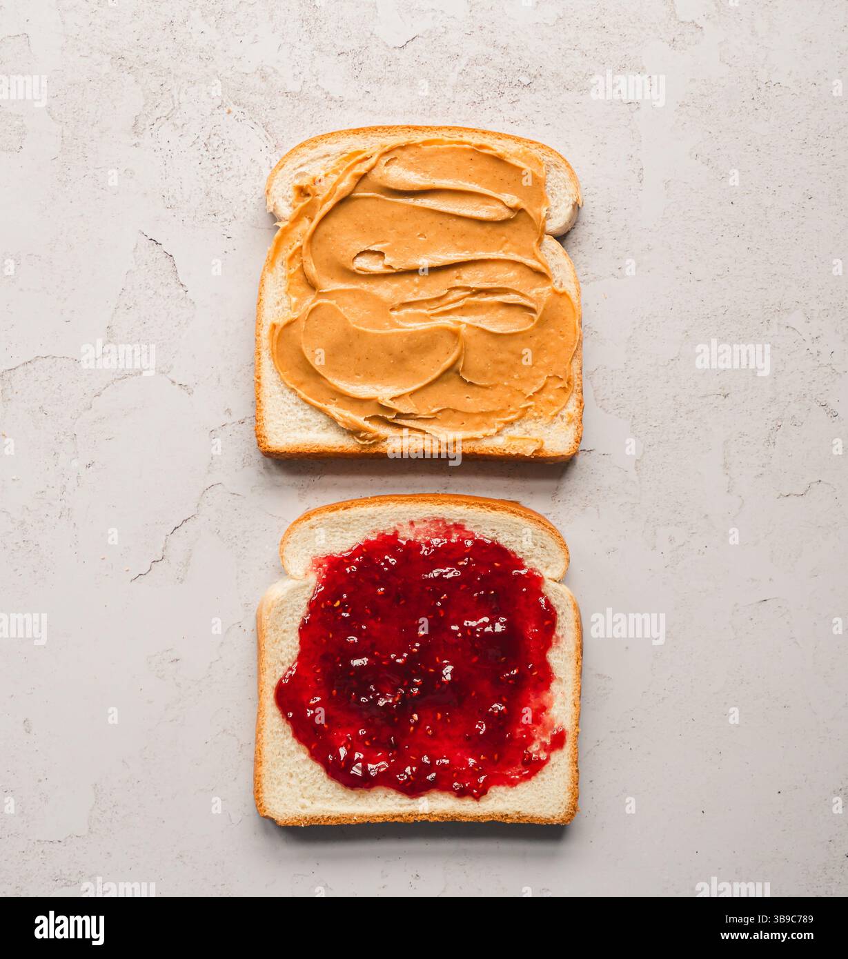 Top view peanut butter and jam spread onto slices of white bread Stock ...