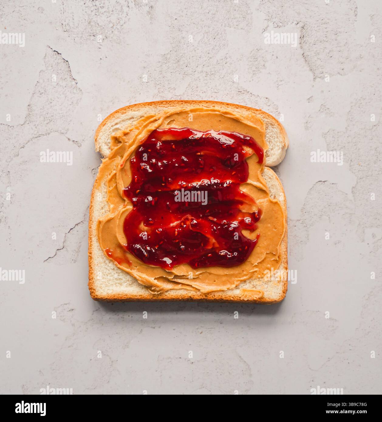 Top view peanut butter and jam spread onto slice of white bread Stock ...