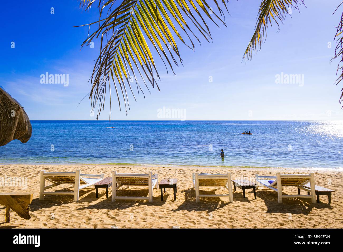 Tropical beach with white sand on a sunny day. Binucot Beach, Ferrol ...