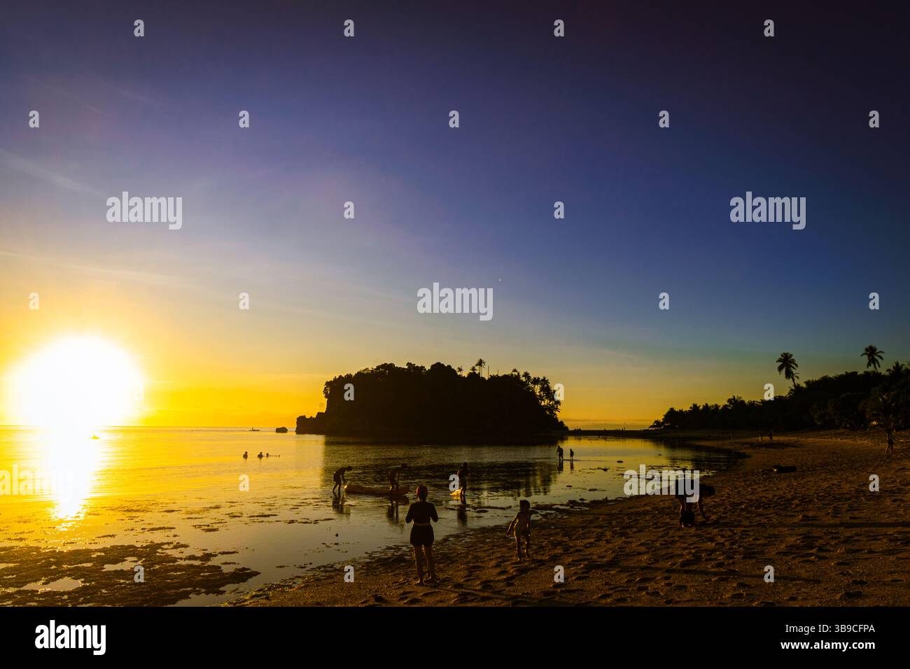 Tropical beach with white sand at sunset. Binucot Beach, Ferrol ...
