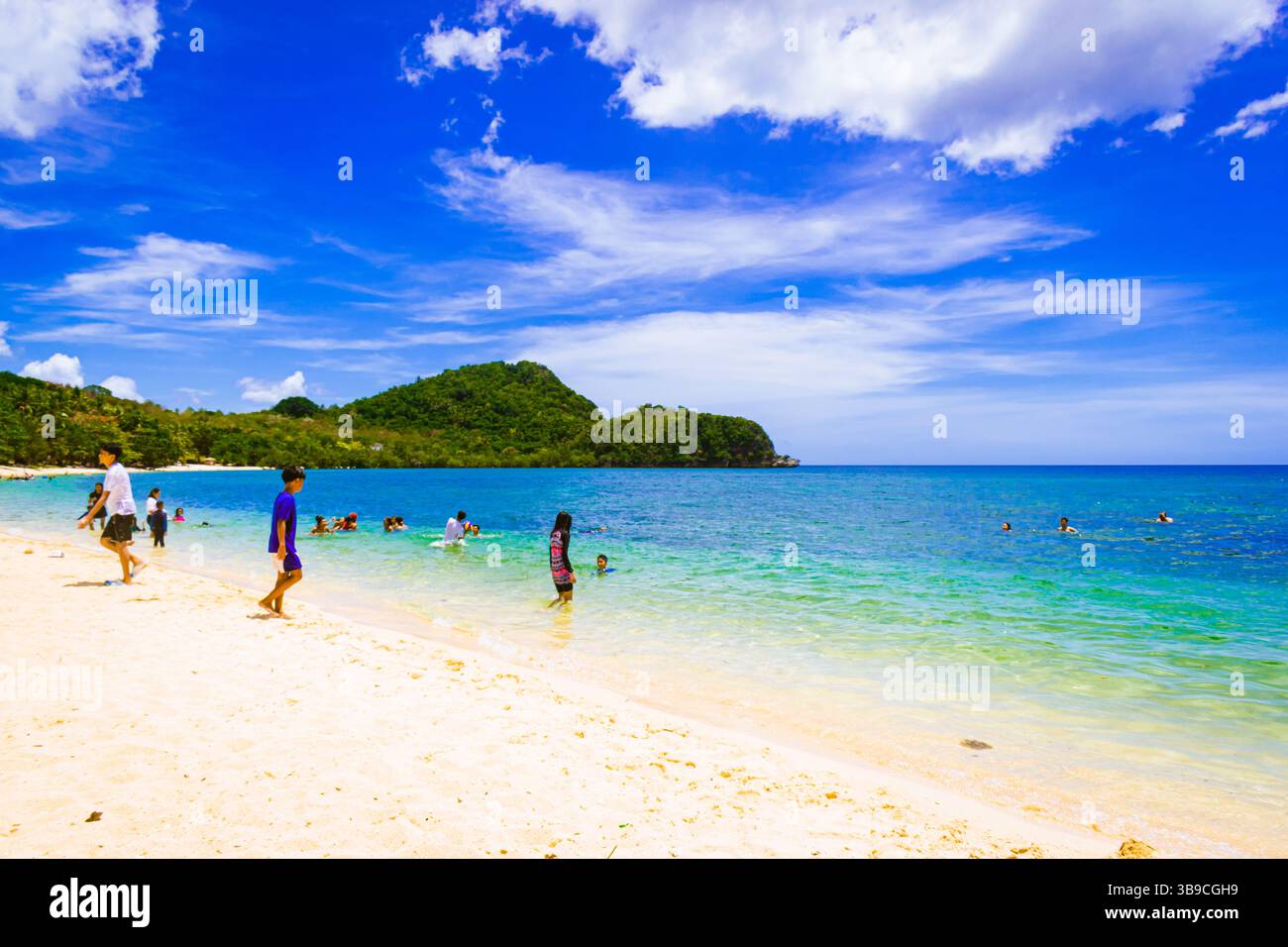 Tropical beach with white sand on a sunny day. Binucot Beach, Ferrol ...