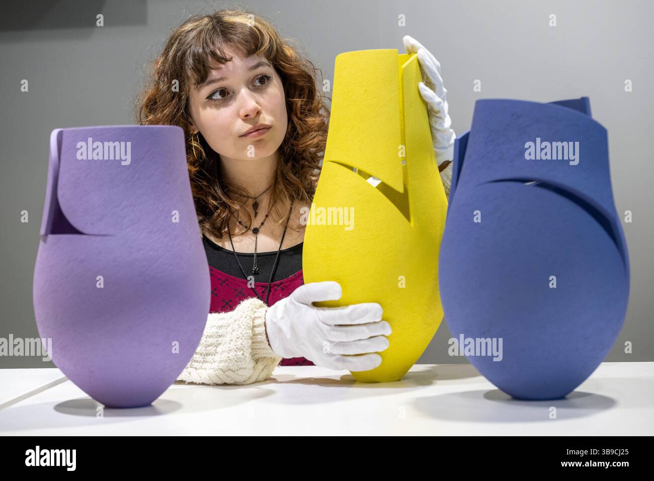 London, UK. 9 May 2025. A staff member poses with creations by Egyptian born British artist ...