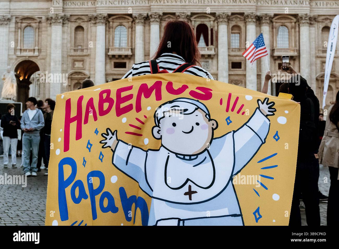 A woman seen with a flag quoting Habemus Papam-We have the Pope in St ...
