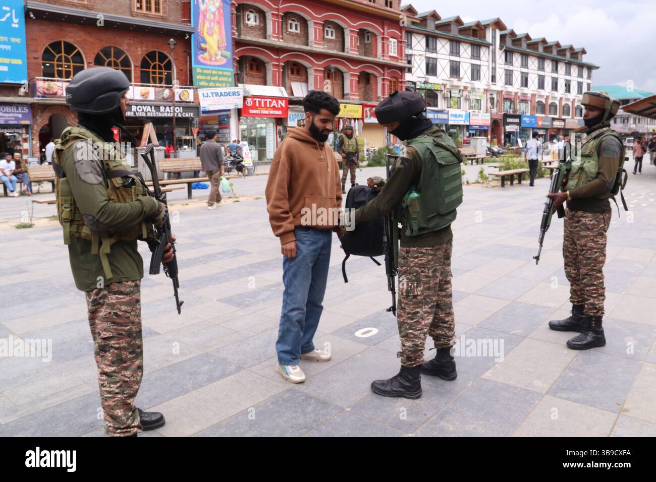 Indian security personnel conduct thorough checks on a civilian at Lal Chowk in Srinagar, amid ...