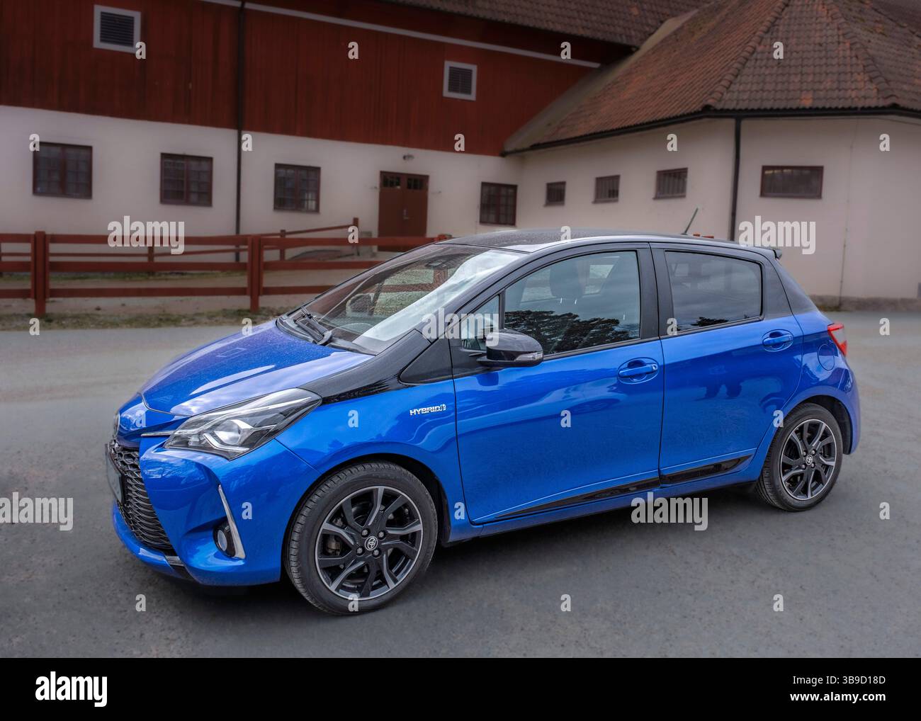A new bue Toyota Yaris parked in front of a horse stable Stock Photo ...
