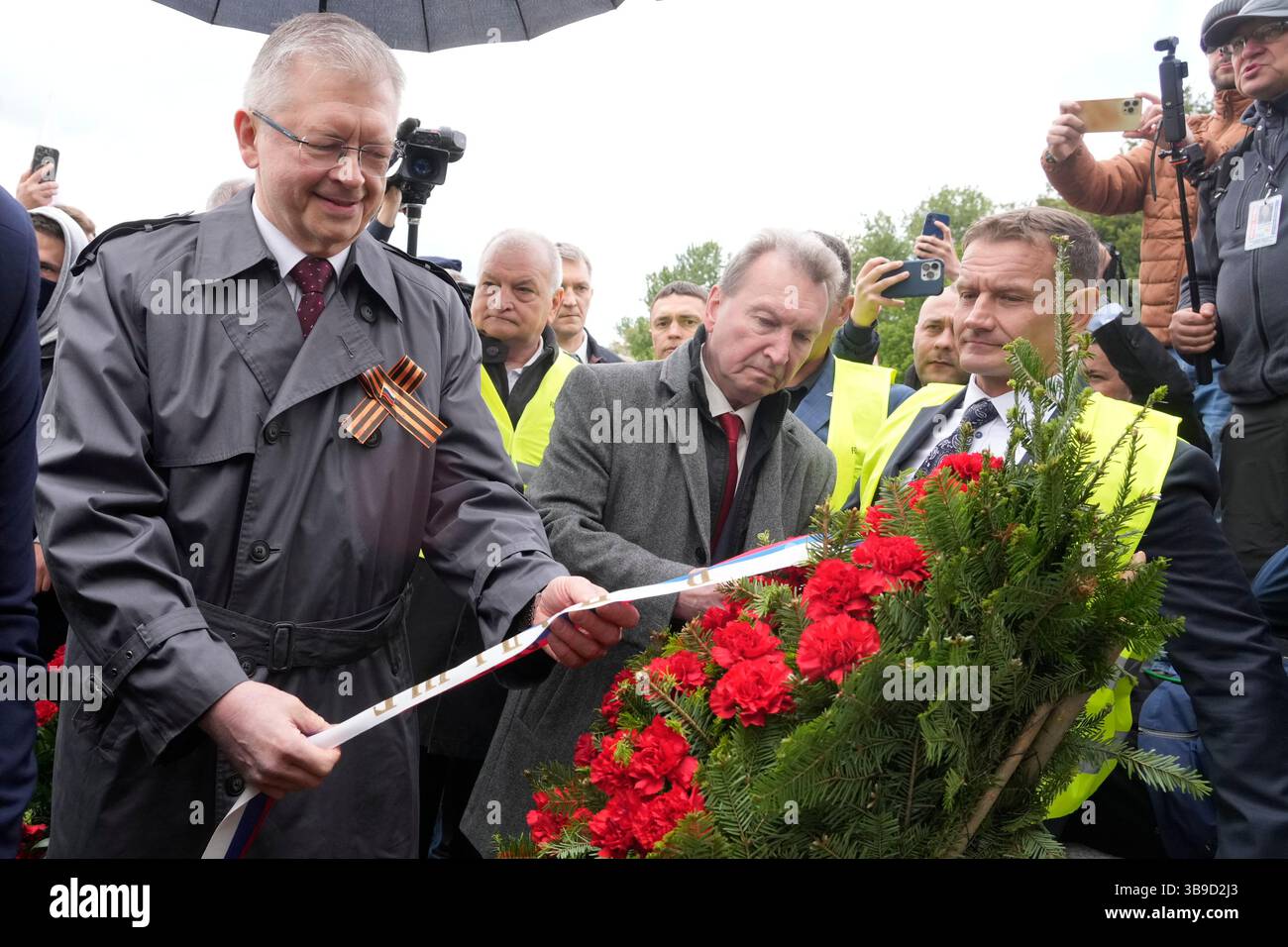 Russia's Ambassador to Poland Sergey Andreev, left, lays a wreath at the Soviet soldier ...