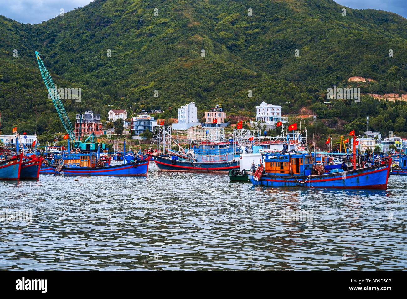 Vietnamese fishing boats and ships with sailors in the harbor at sea in ...