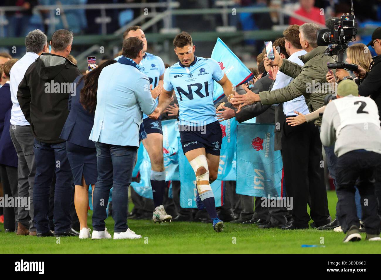 SYDNEY, AUSTRALIA - MAY 09: Jake Gordon of the Waratahs leads his ...