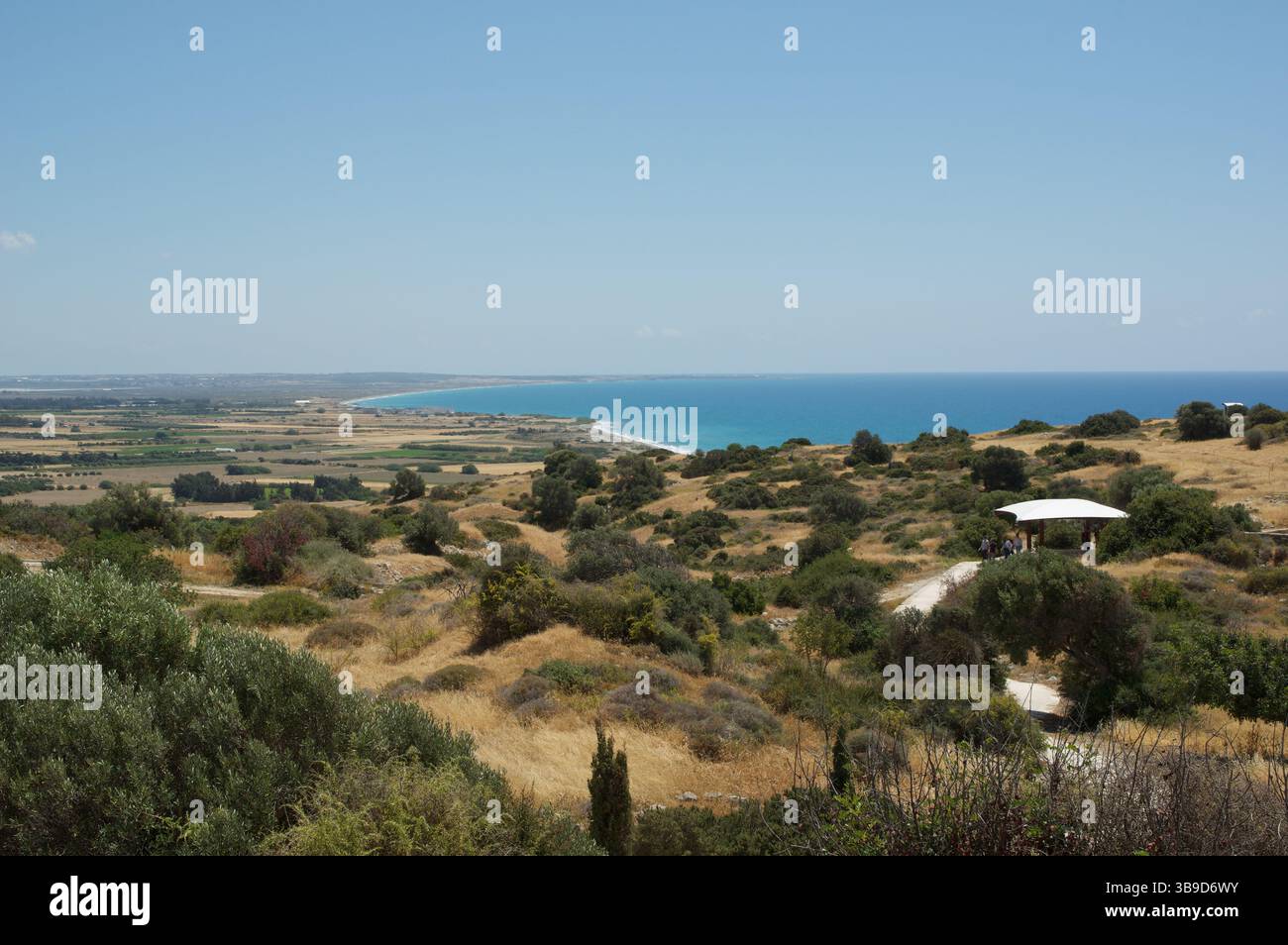 A picturesque view featuring a coastal landscape with green vegetation ...