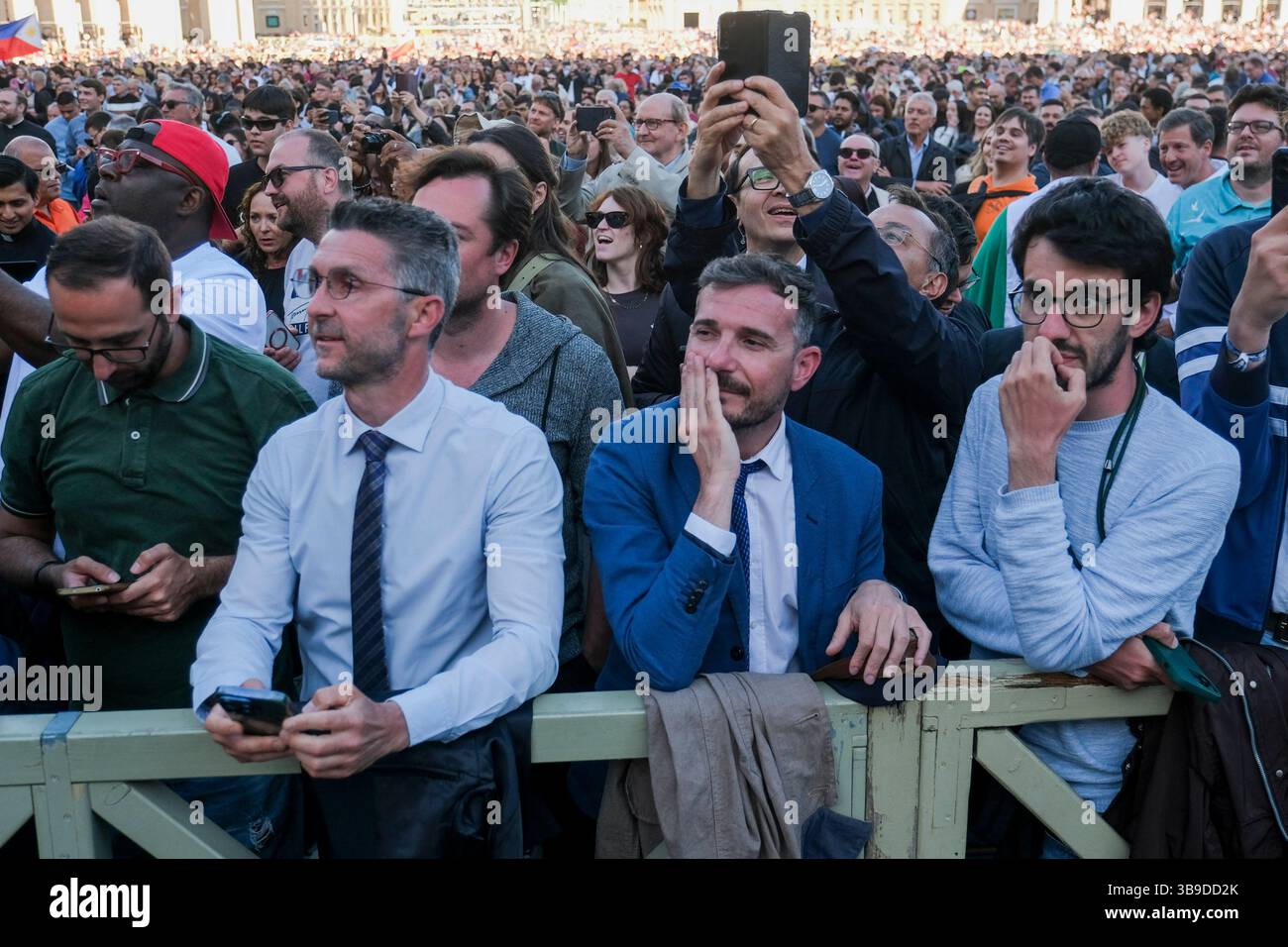 people in st. peter's square watch the chimney of the sistine chapel ...