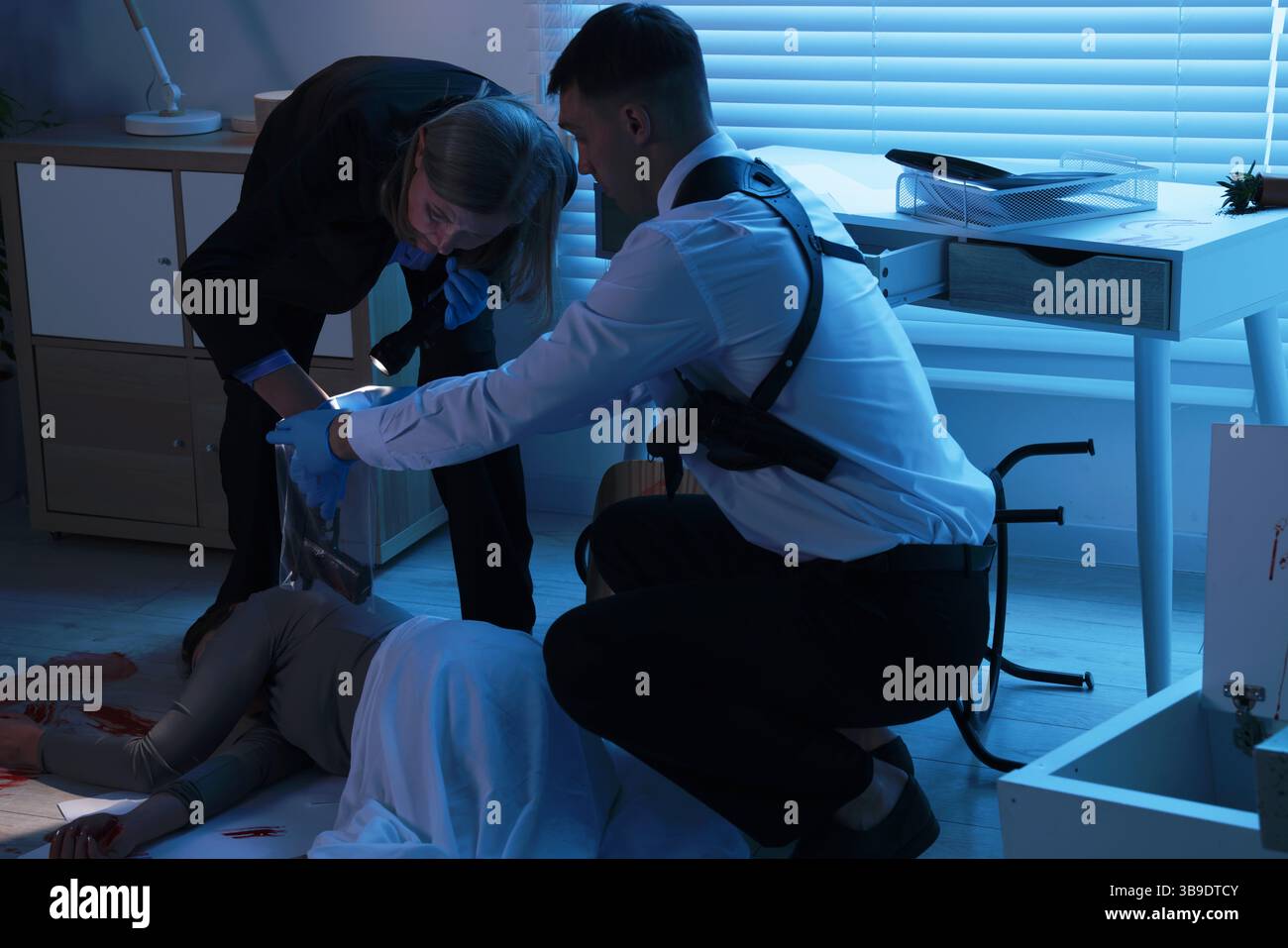 Forensic experts working at crime scene with dead woman's body indoors ...