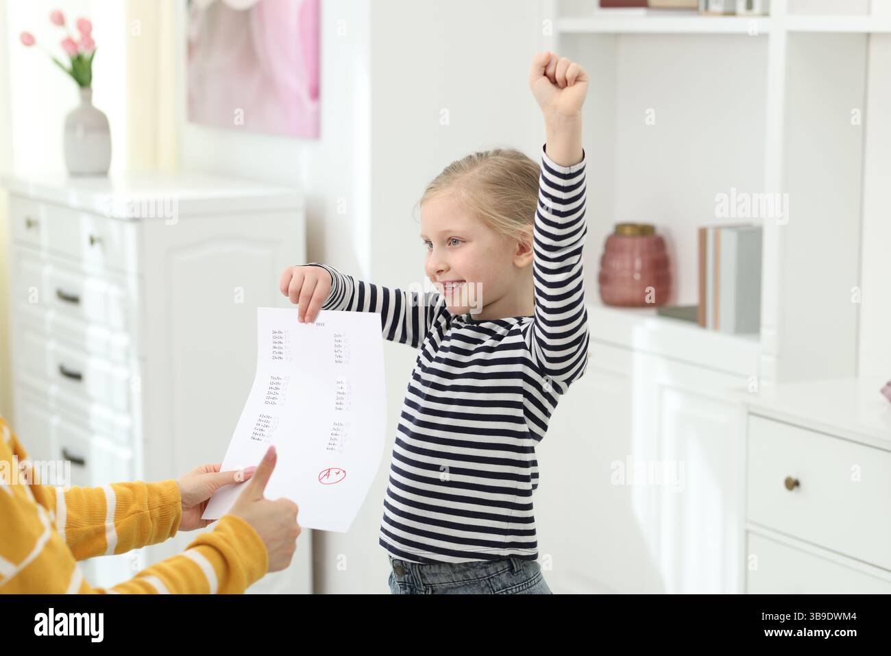 School grade. Happy girl showing answer sheet with excellent mark to ...