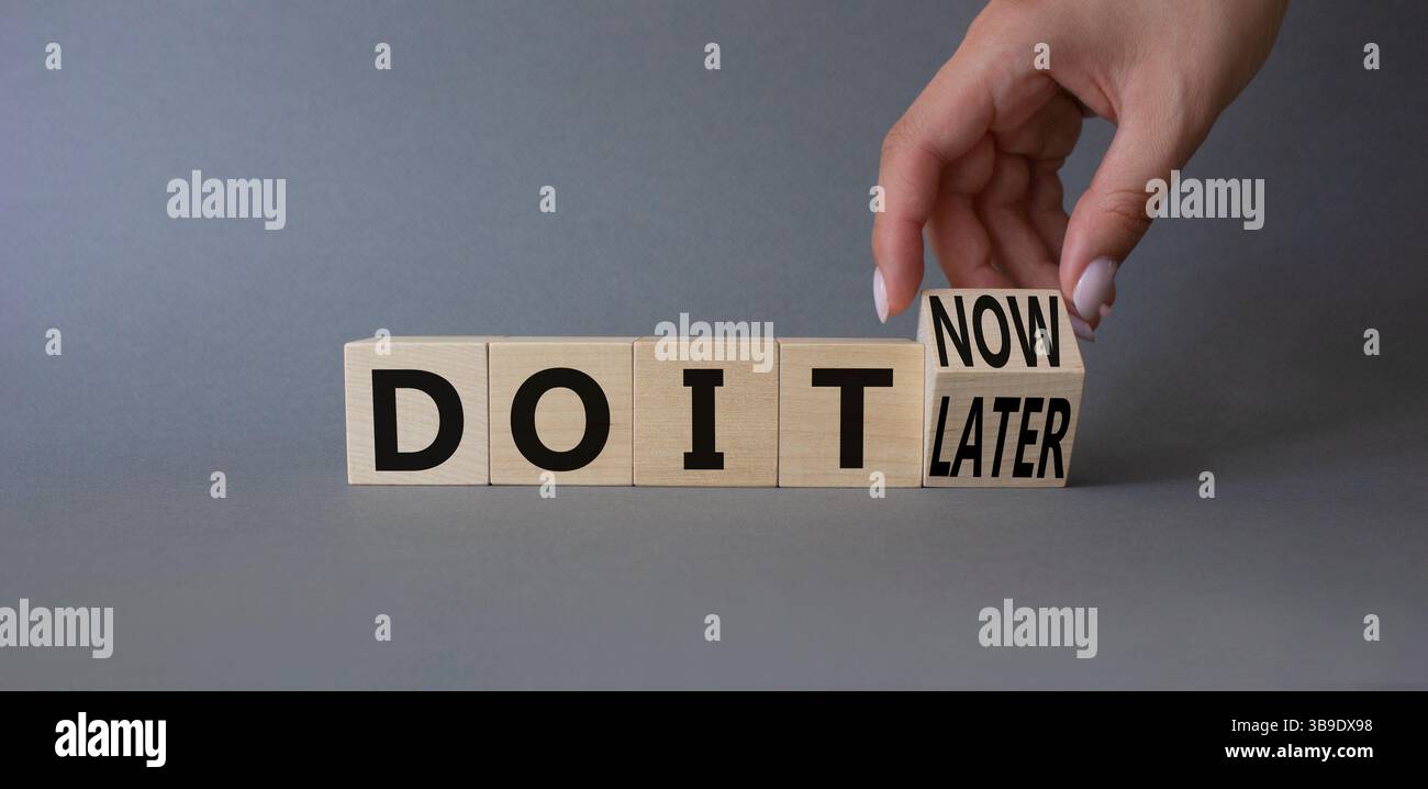 Do it now or later symbol. Businessman hand turnes wooden cubes and ...