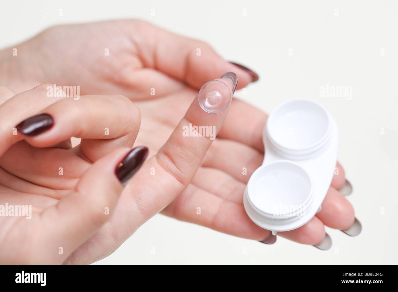 Woman holds contact lens. Close up of hands. Lens on fingertip. Optical ...