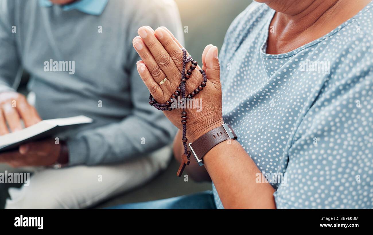 Hands, rosary and couple religion with bible in home to worship Jesus Christ, spiritual faith ...