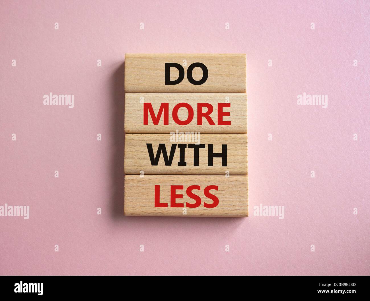 Do more with less symbol. Concept words Do more with less on wooden ...