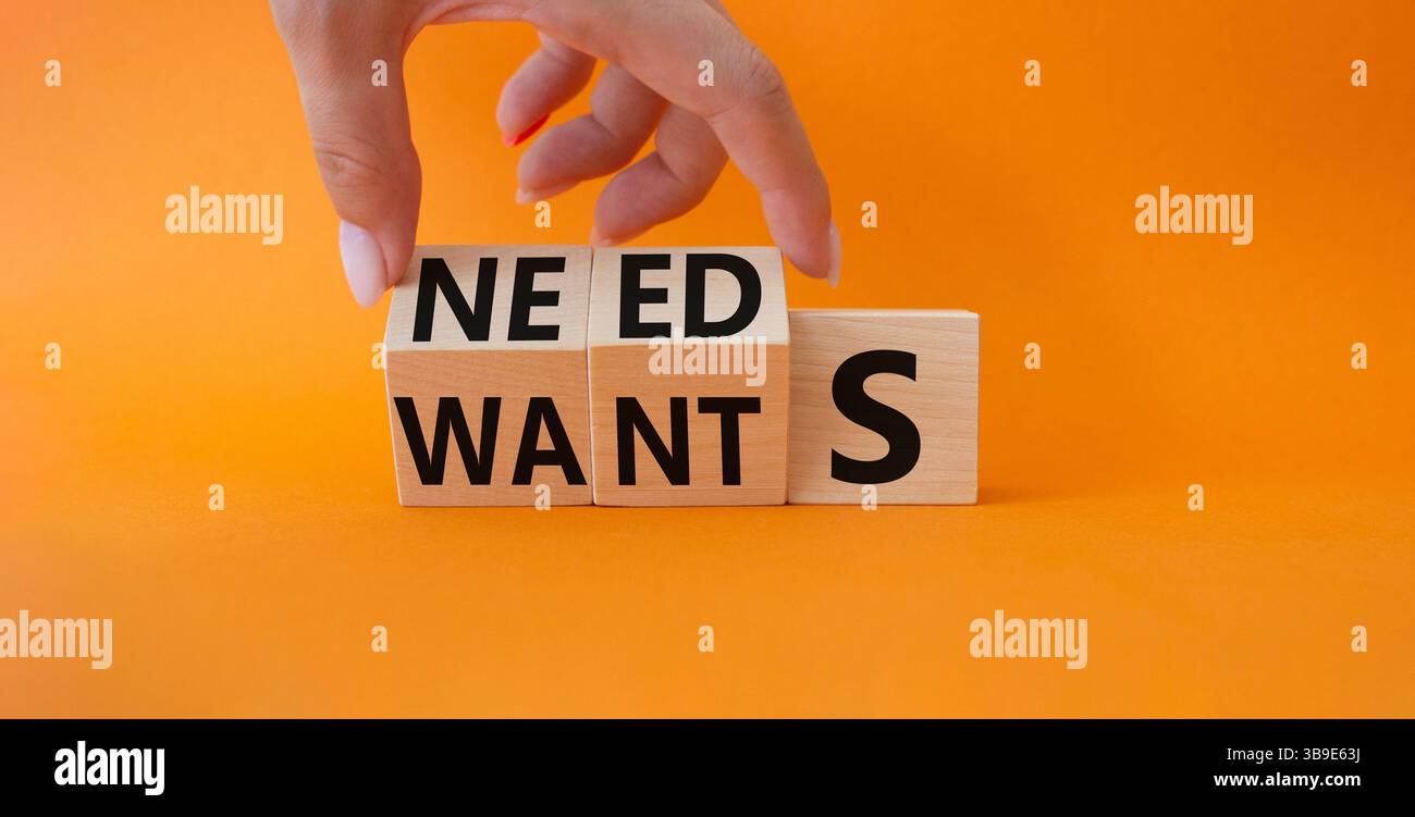 Needs and Wants symbol. Businessman Hand turns cubes and changes word ...